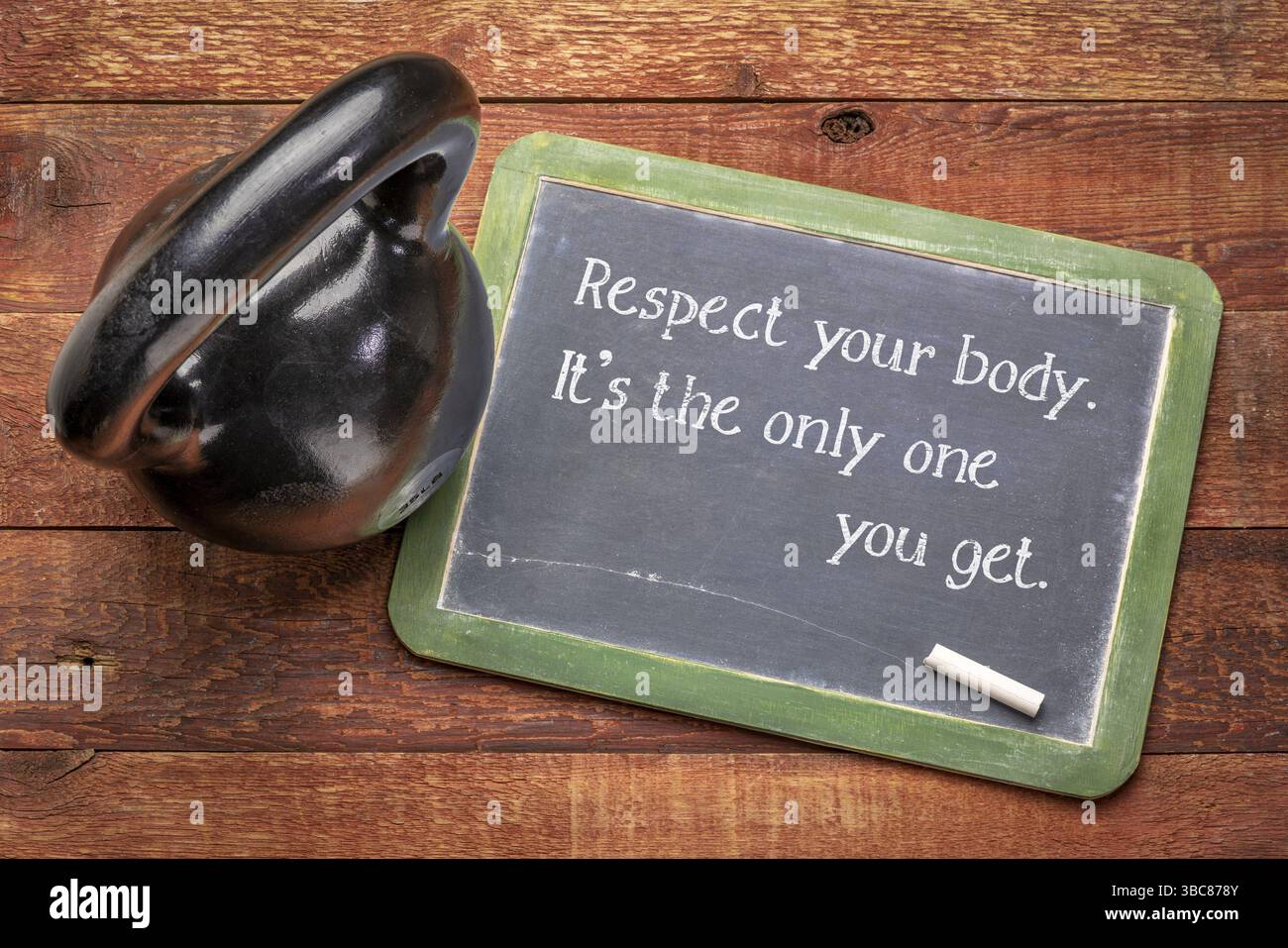 Respect your body inspirational text on blackboard with a kettlebell ...