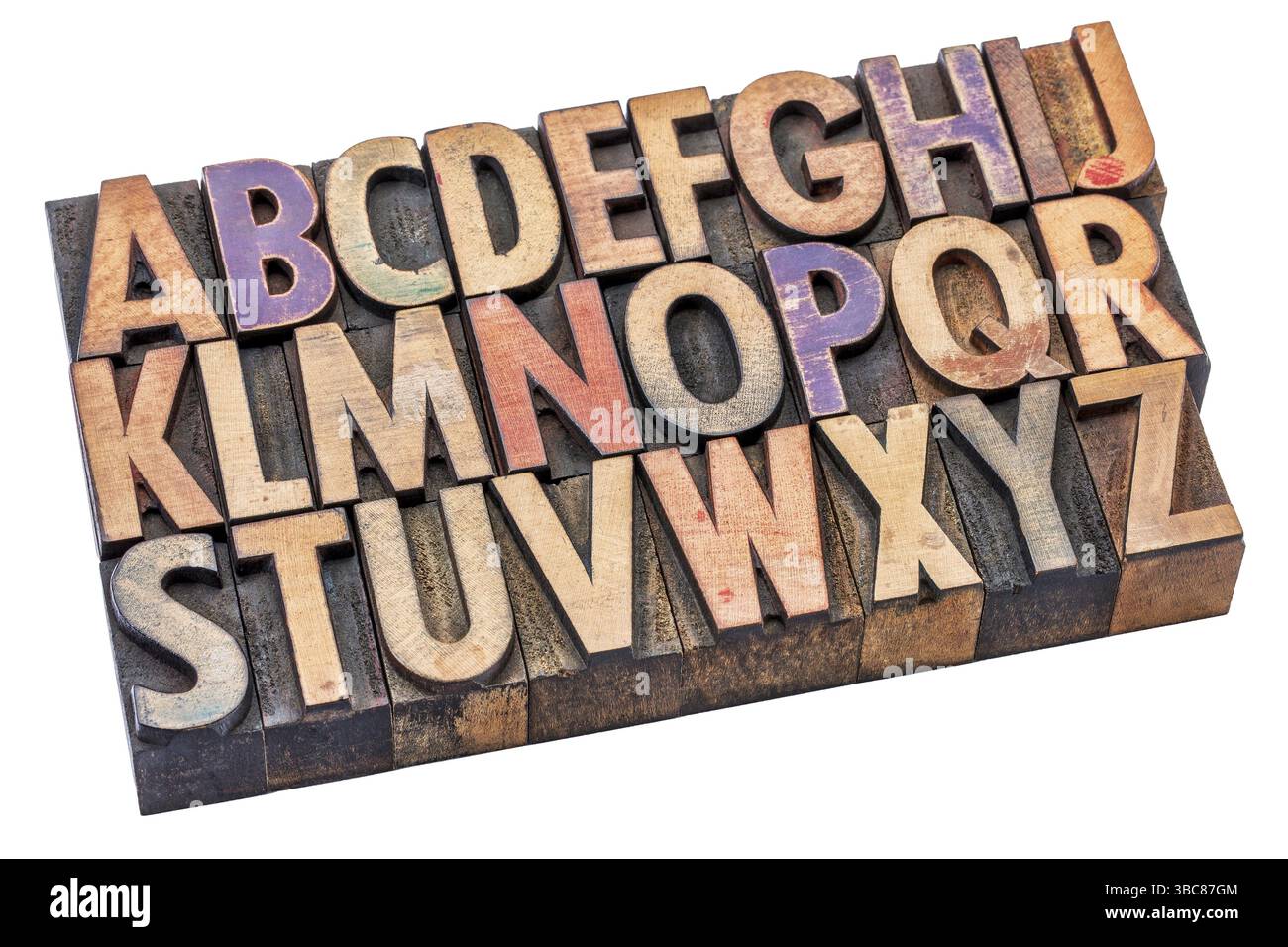 English alphabet in vintage letterpress wood type stained by color inks ...