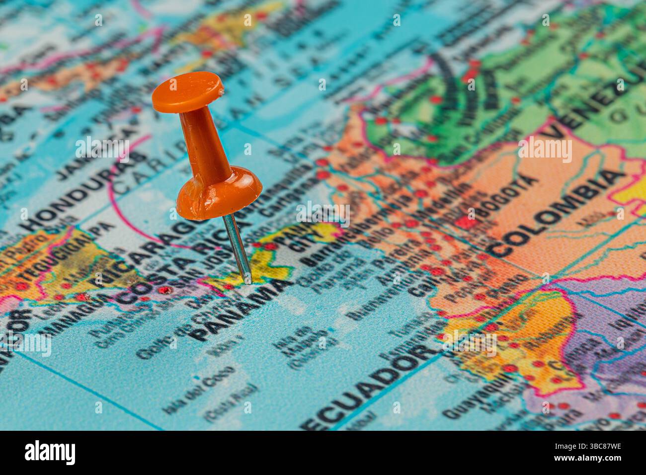 An orange pushpin marks the location of Panama on a colorful map ...