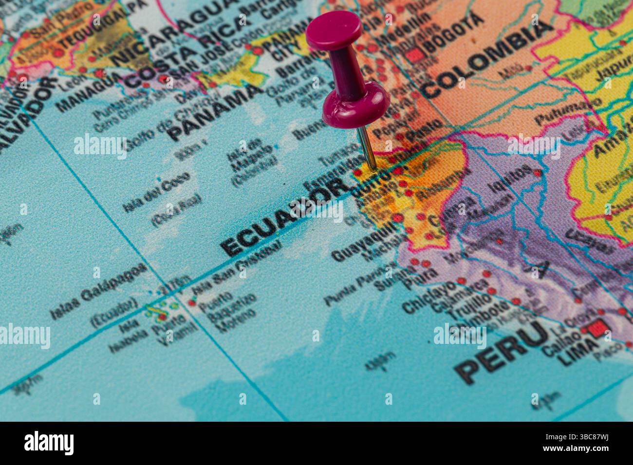 A red pushpin marks Ecuador on a colorful map of South America ...
