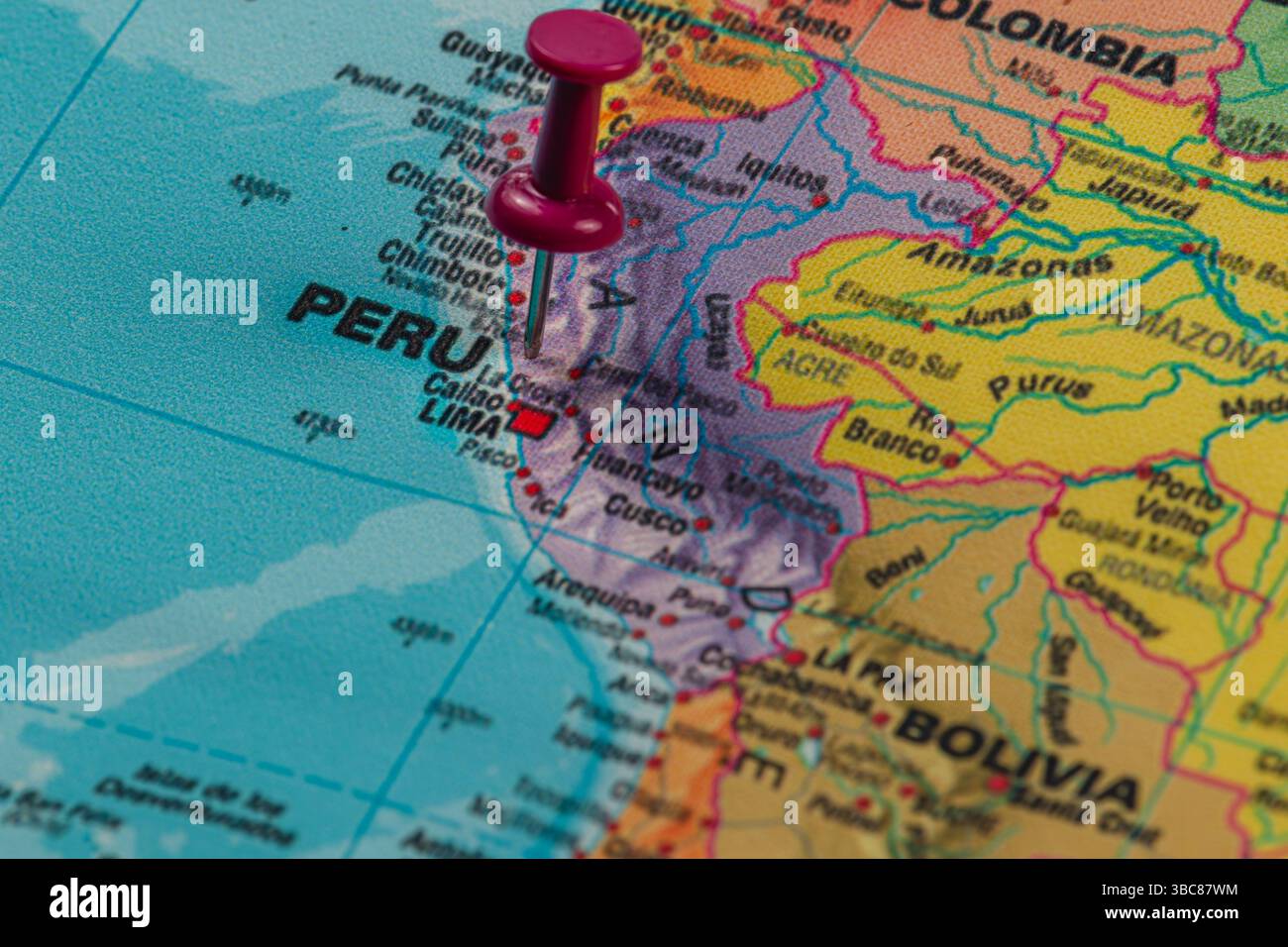 A detailed map showcases Peru, with a red pin marking the location of ...