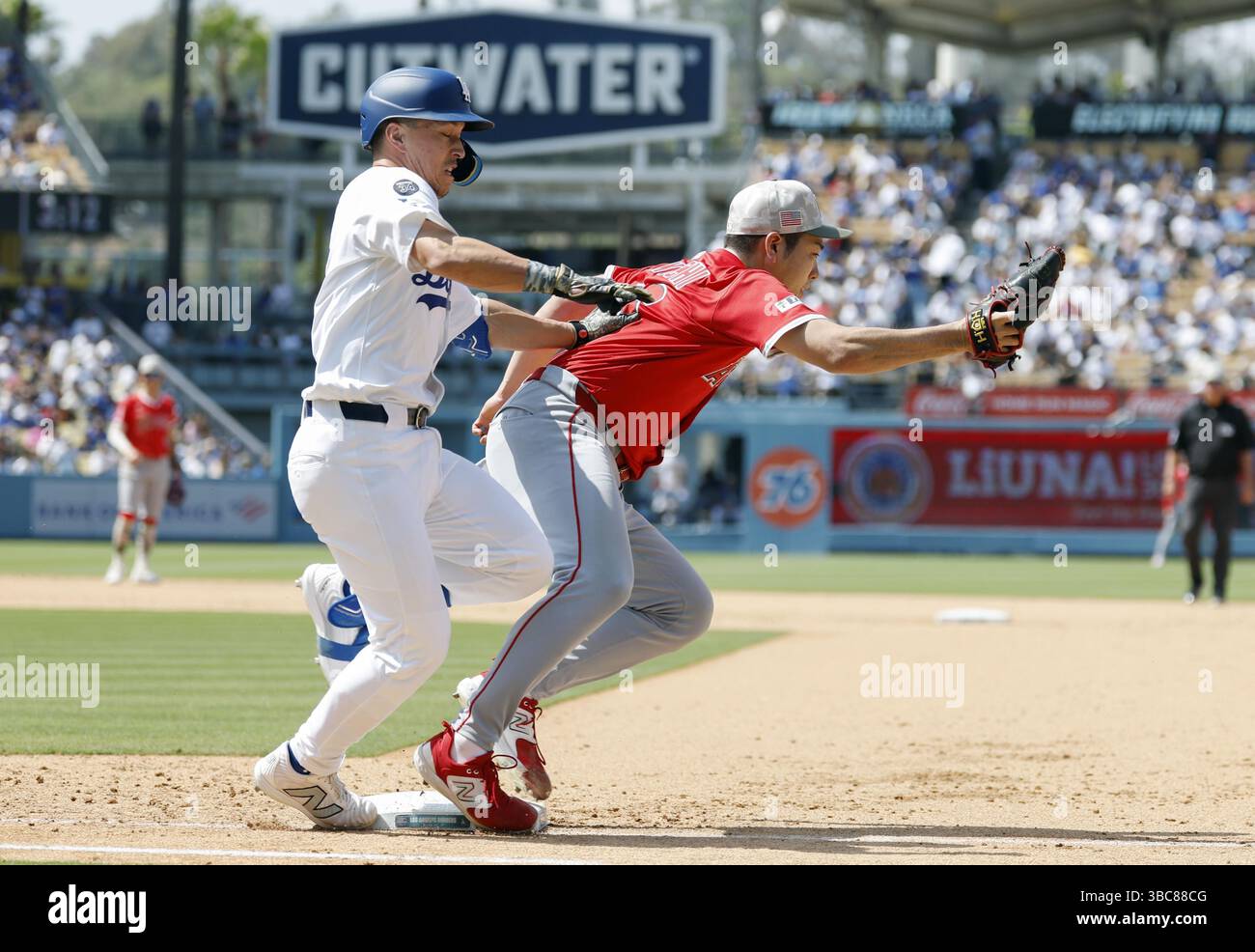 Los Angeles Angels pitcher Yusei Kikuchi (R) collides Tommy Edman of the Los Angeles Dodgers ...