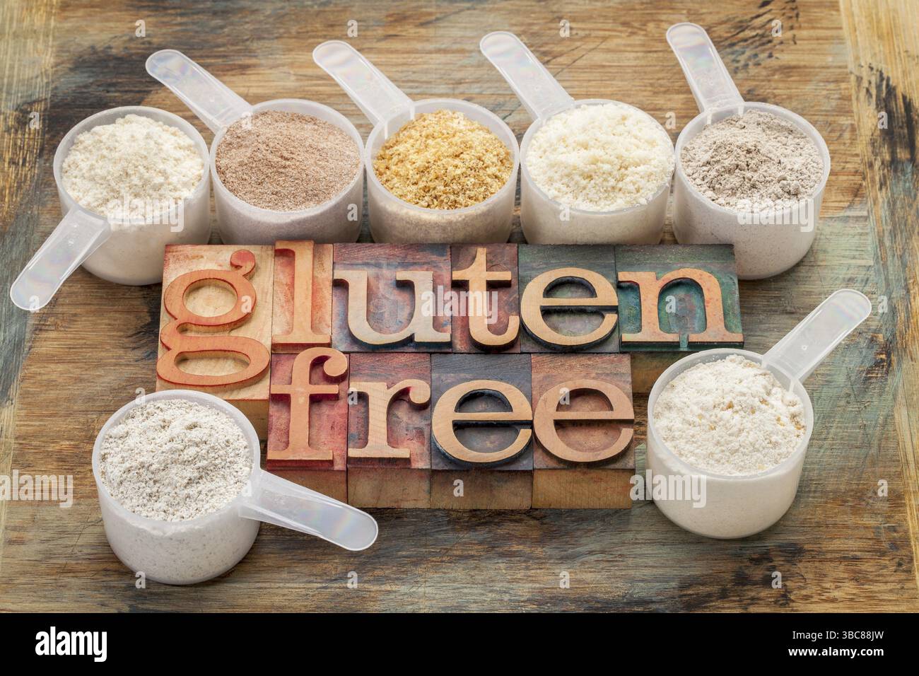 Measuring scoops of gluten free flours (almond, coconut, teff, flaxseed ...