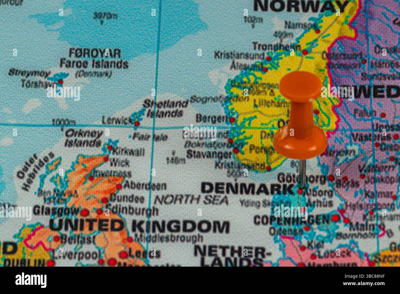 An orange pushpin marks a specific location in Denmark on a colorful ...