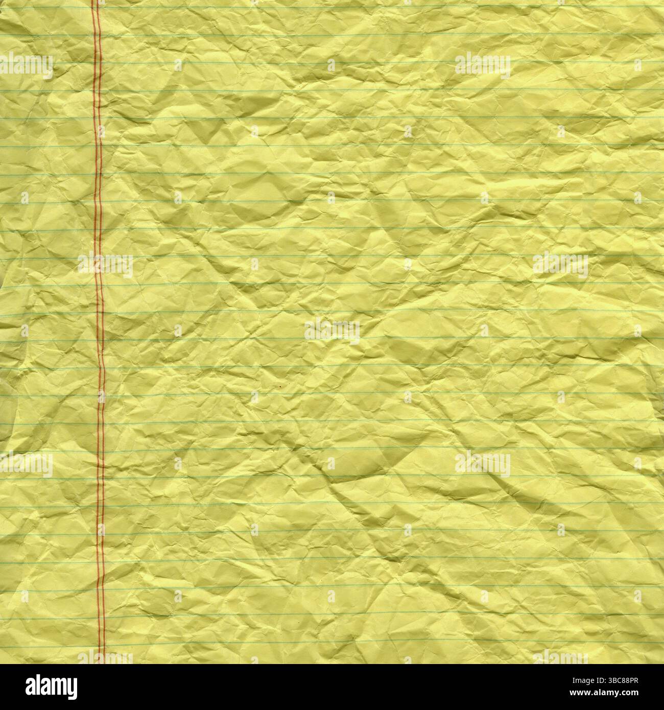 Crumpled yellow notebook page with green lines and red margin Stock ...