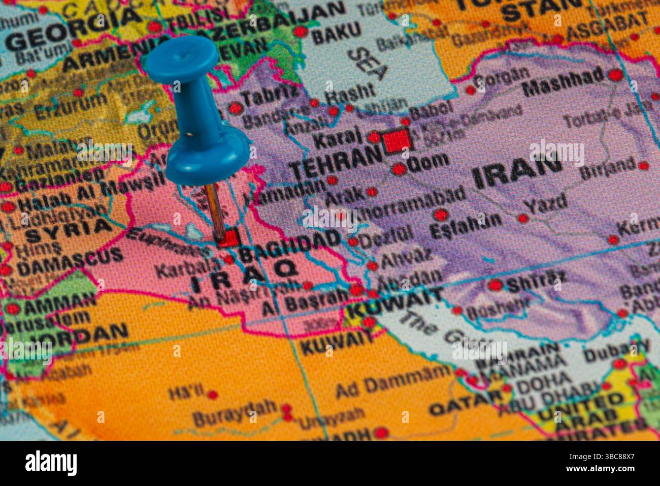A detailed map of the Middle East focuses on Iraq, with a blue pushpin ...