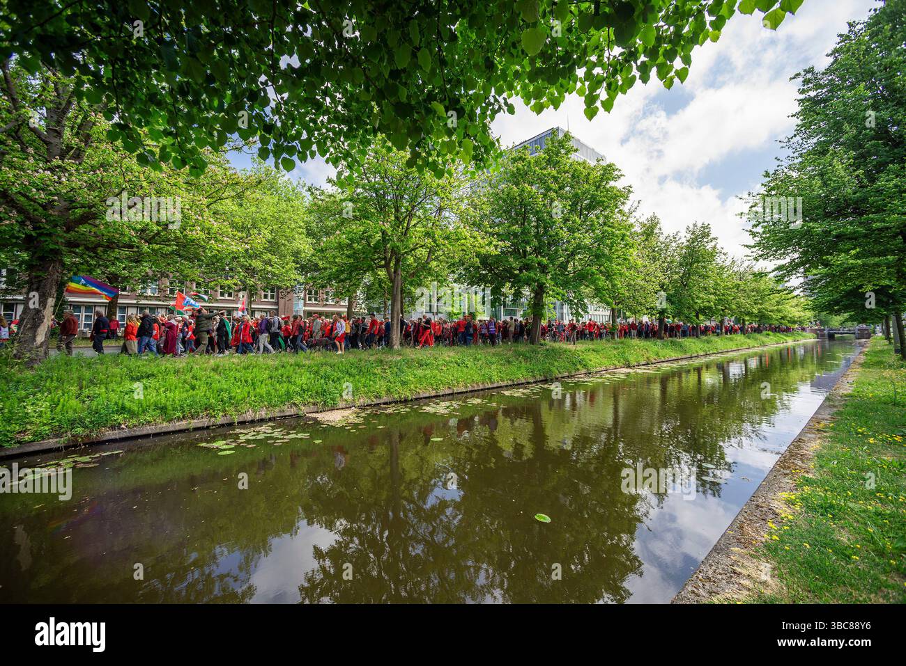 Demonstrators walk past a cannel during ‘THE RED LINE' demonstration ...