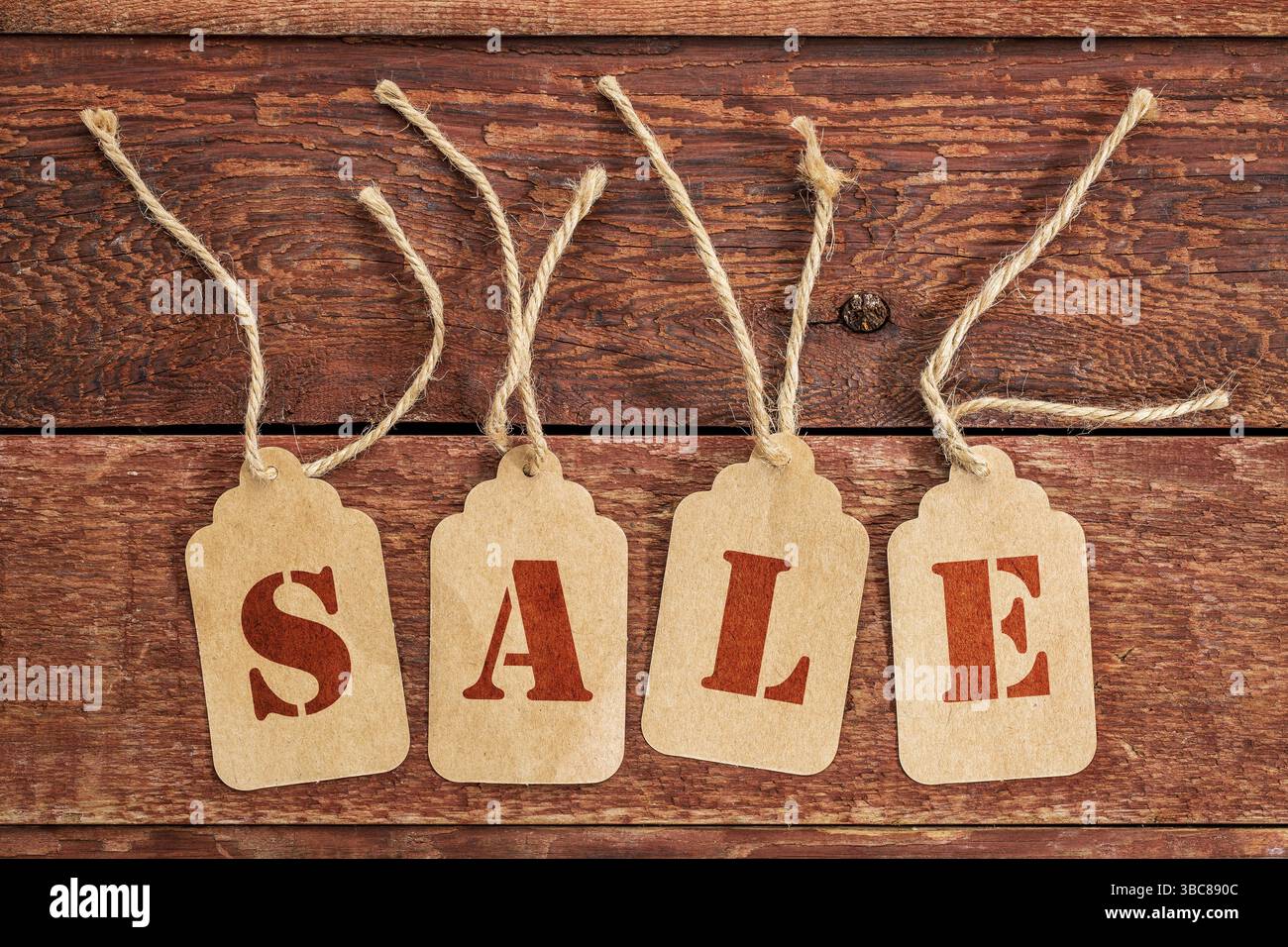 Sale sign or concept - letters on price tags against rustic red painted ...