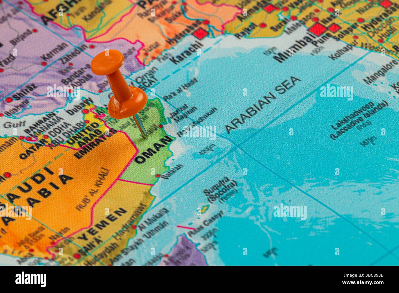 A bright map displays Oman with a red pin marking its location in the ...