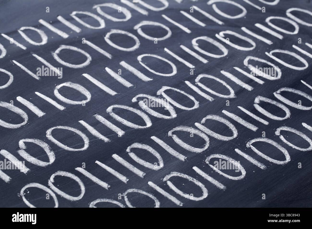 Binary code abstract - rows of zero and one numbers in white chalk handwriting on blackboard ...