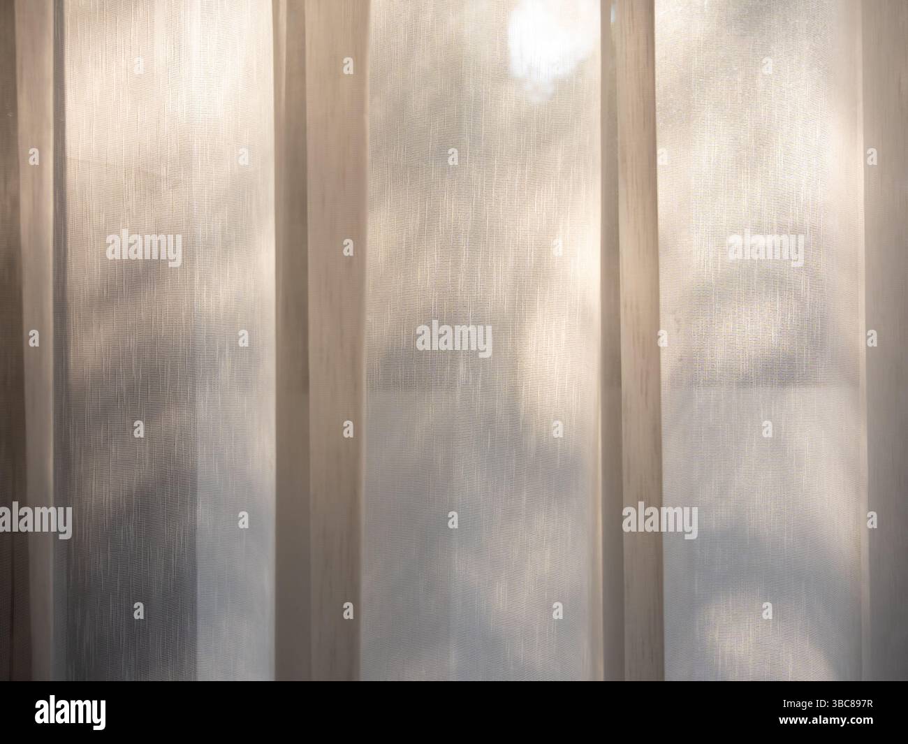 Close-up white transparent curtain on window in the bedroom with warm ...