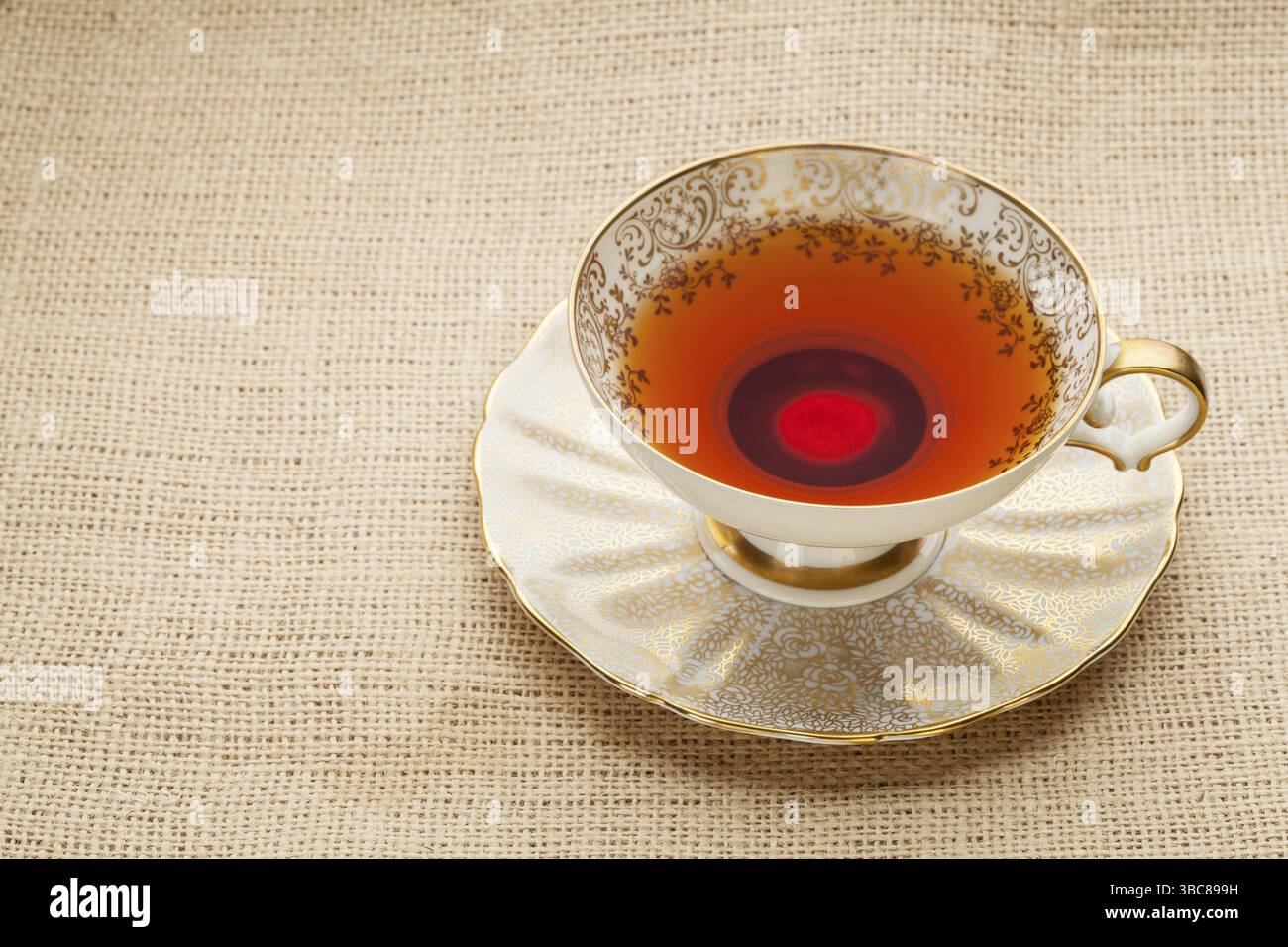 Afternoon tea - antique cup of black tea on canvas (burlap)background ...