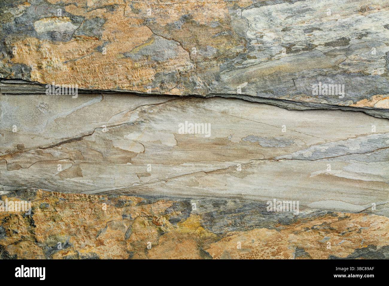 Two layers of flat, multi color foliated slate rock Stock Photo - Alamy