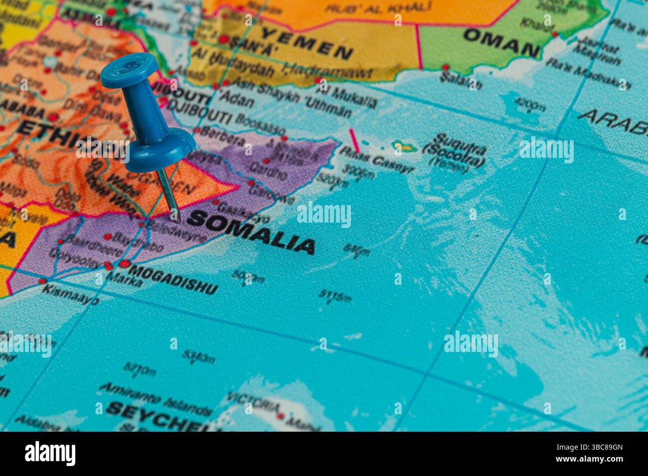 A detailed world map highlights Somalia, with a blue pin marking its ...