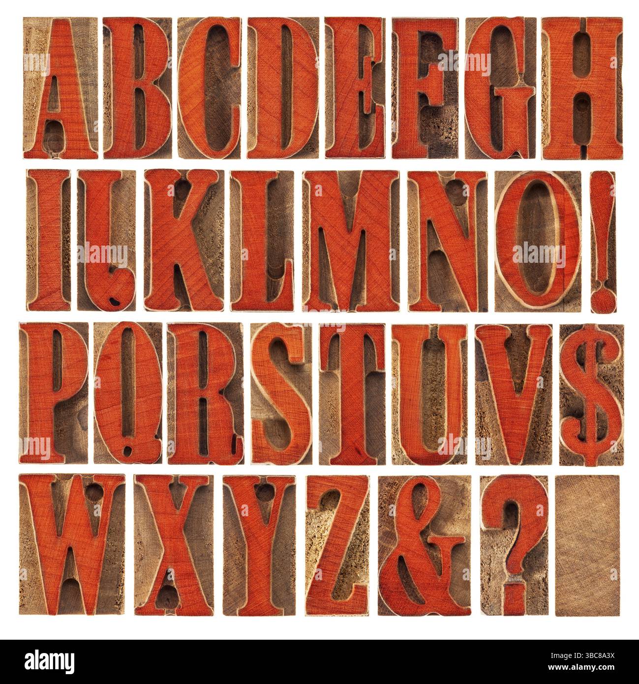 Alphabet in modern letterpress wood type printing blocks stained by red ...