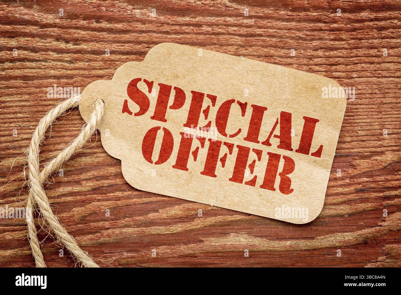 Special offer sign a paper price tag against rustic red painted barn ...