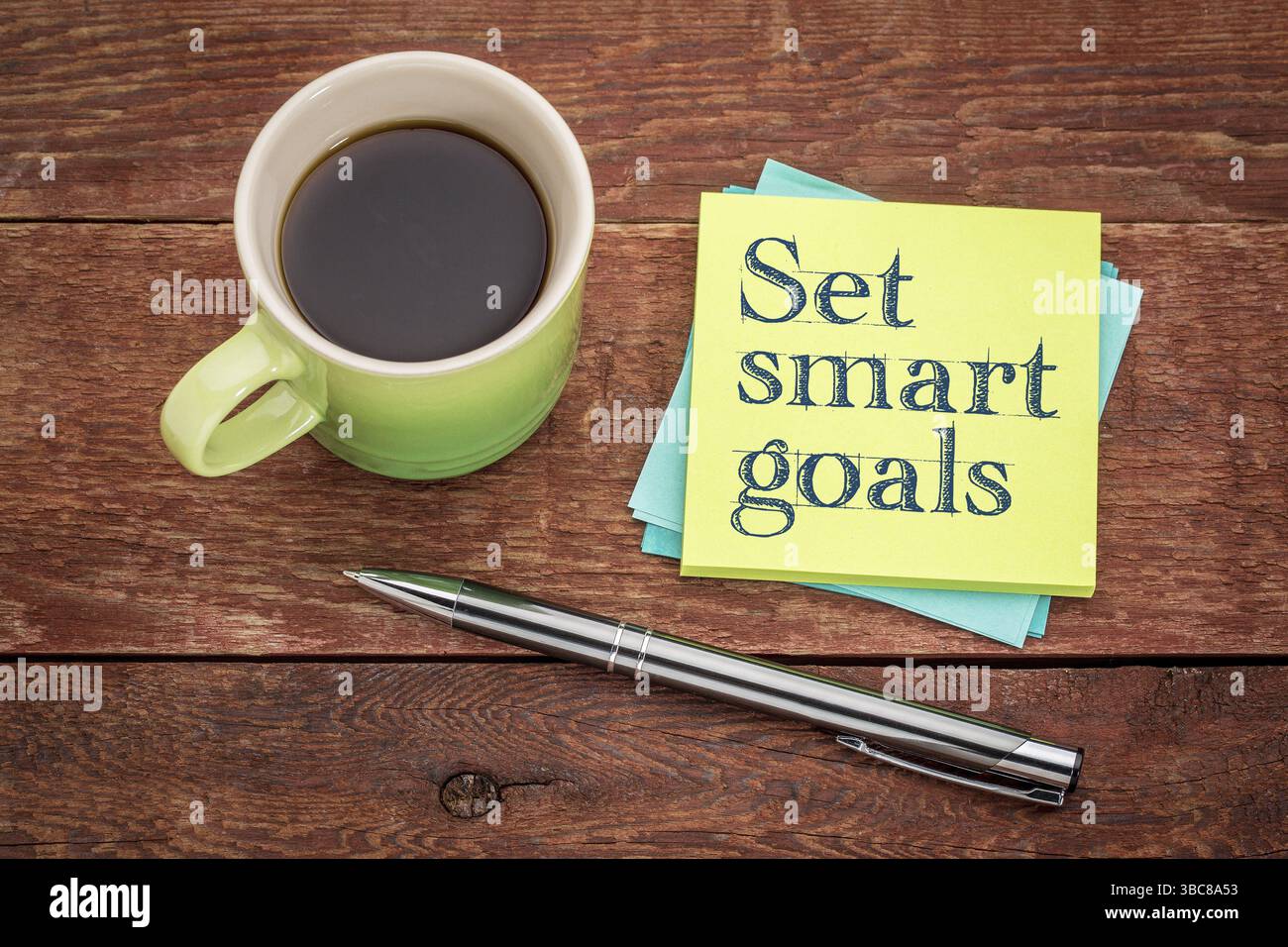 Set smart goals - handwriting on a sticky note with a cup of coffee ...