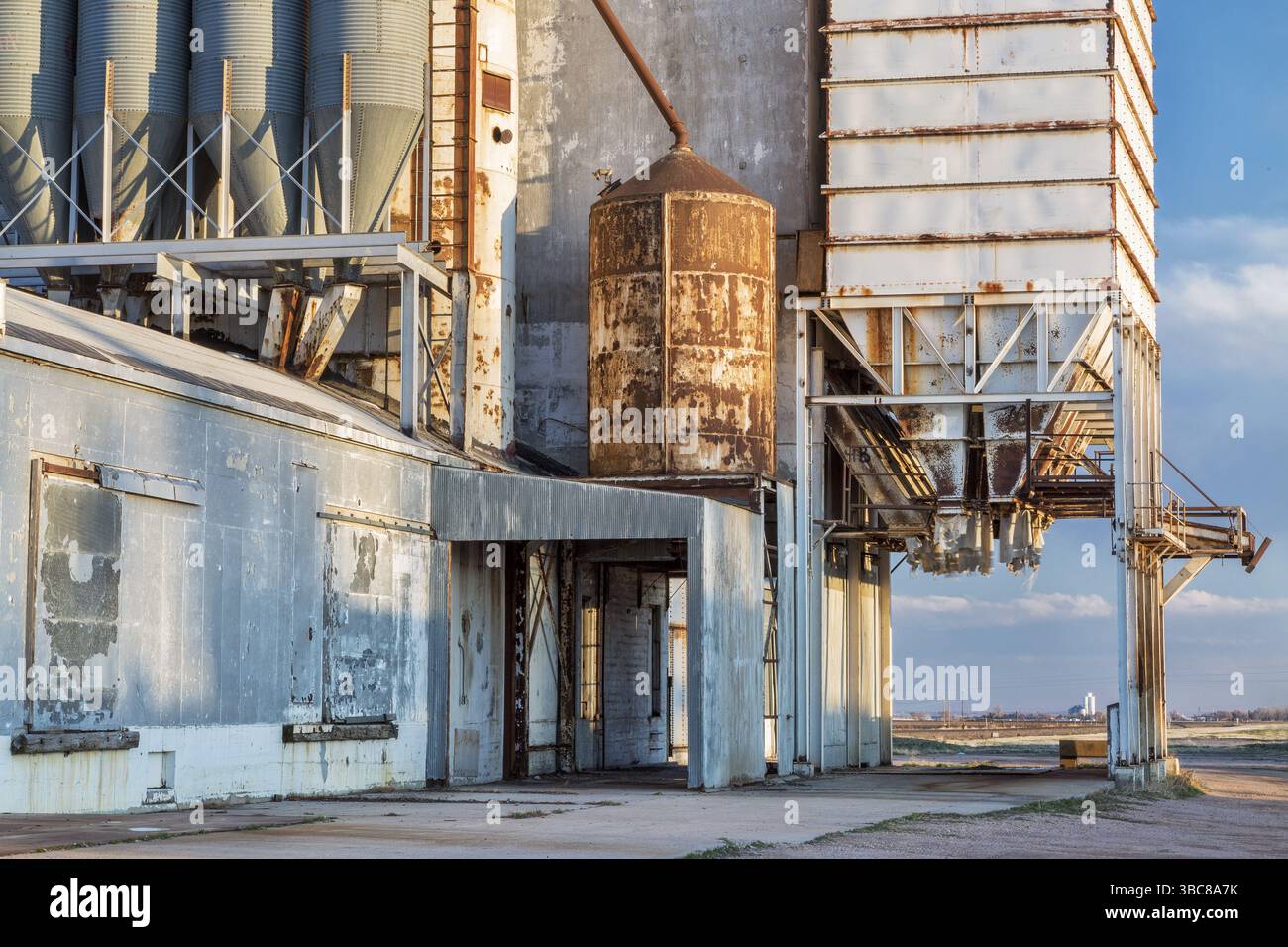 Old grain elevator with pipes, ducts, ladders and chutes, a distant ...