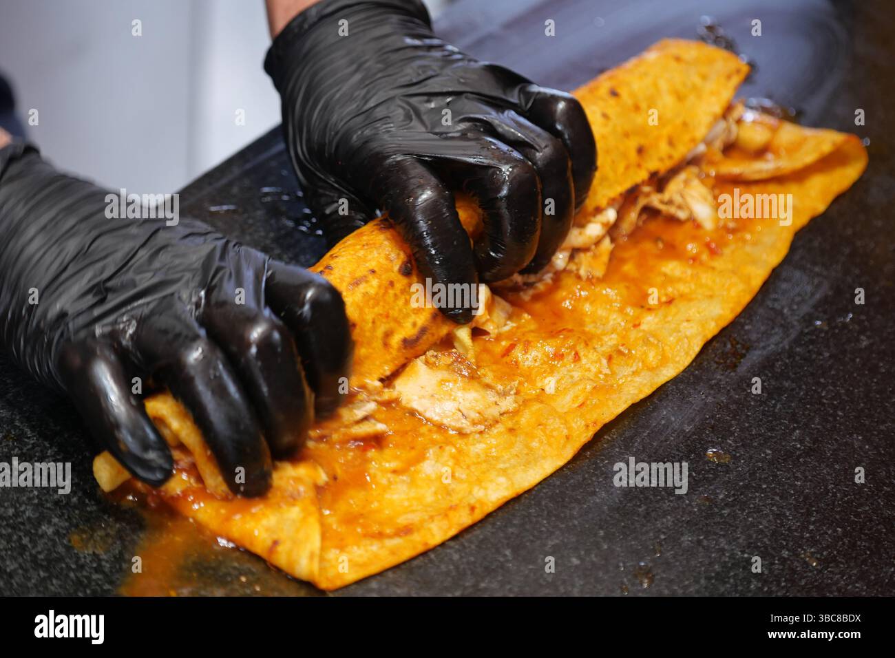 Skilled hands preparing chicken shawarma Stock Photo - Alamy