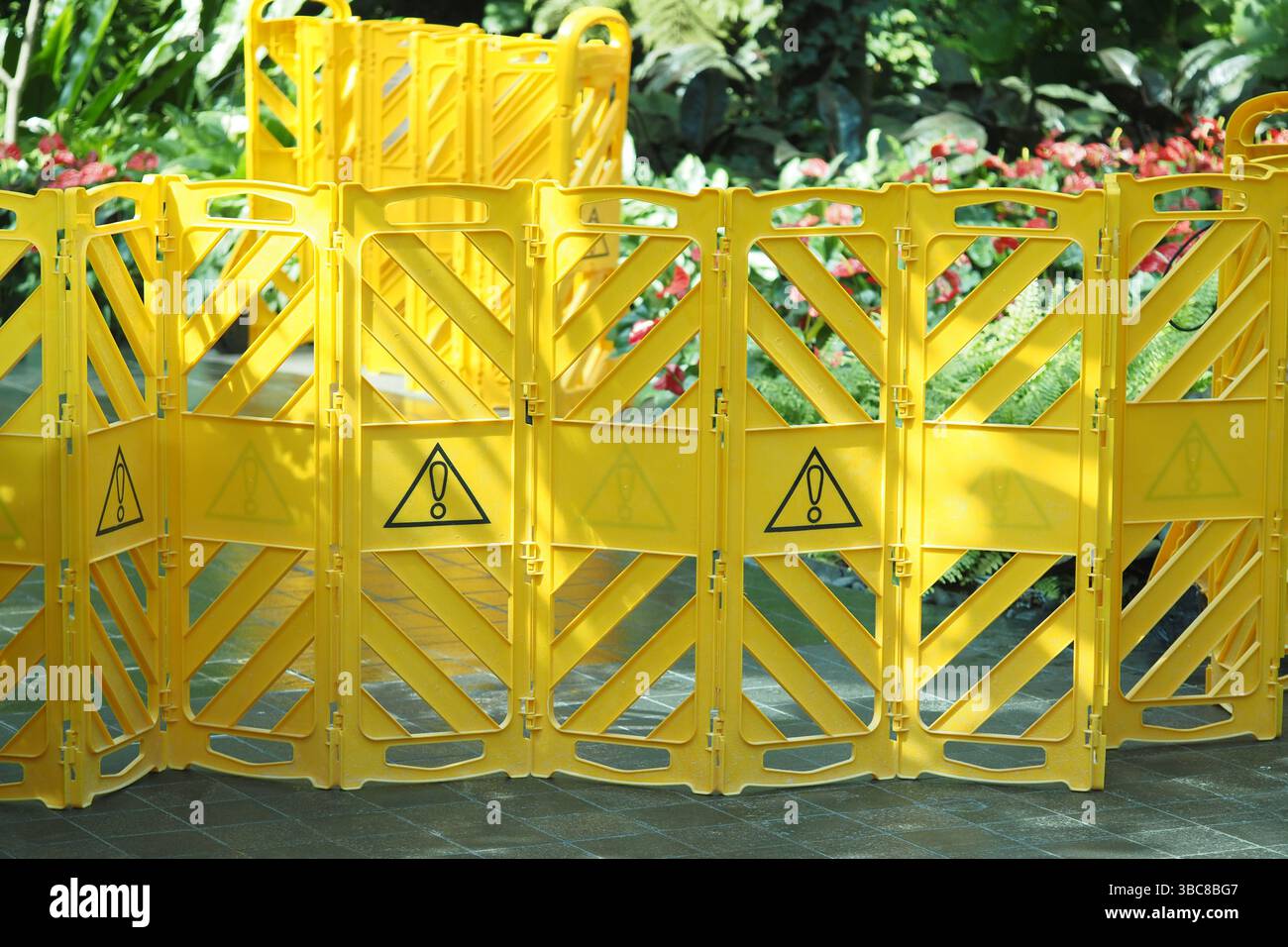 Construction barriers in a vibrant garden setting Stock Photo - Alamy
