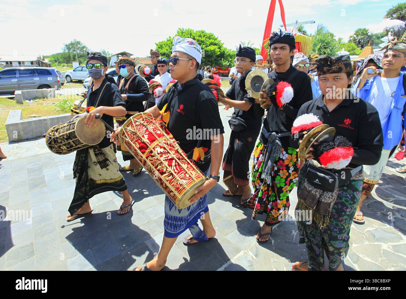 A group of men play traditional Balinese musical instruments during a ...