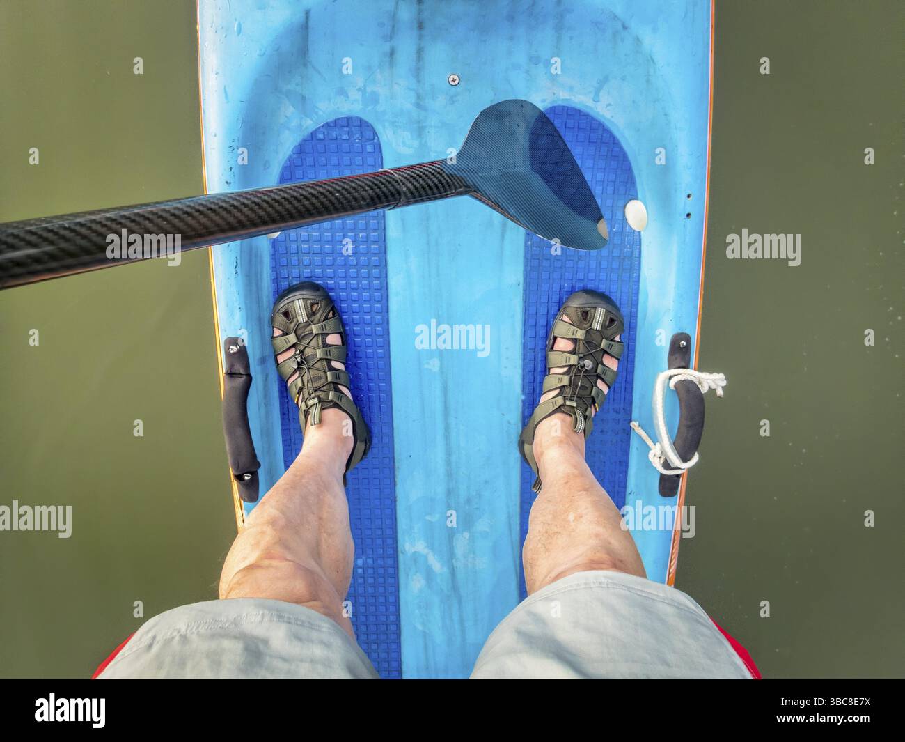 Narrow racing stand up paddleboard with a carbon fiber paddle and ...