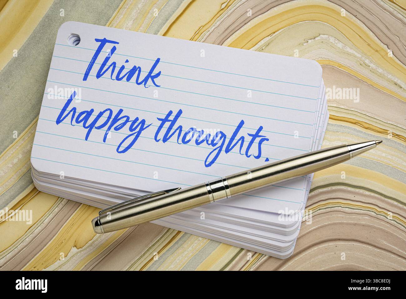 Think happy thoughts reminder - handwriting on a stack of index cards ...