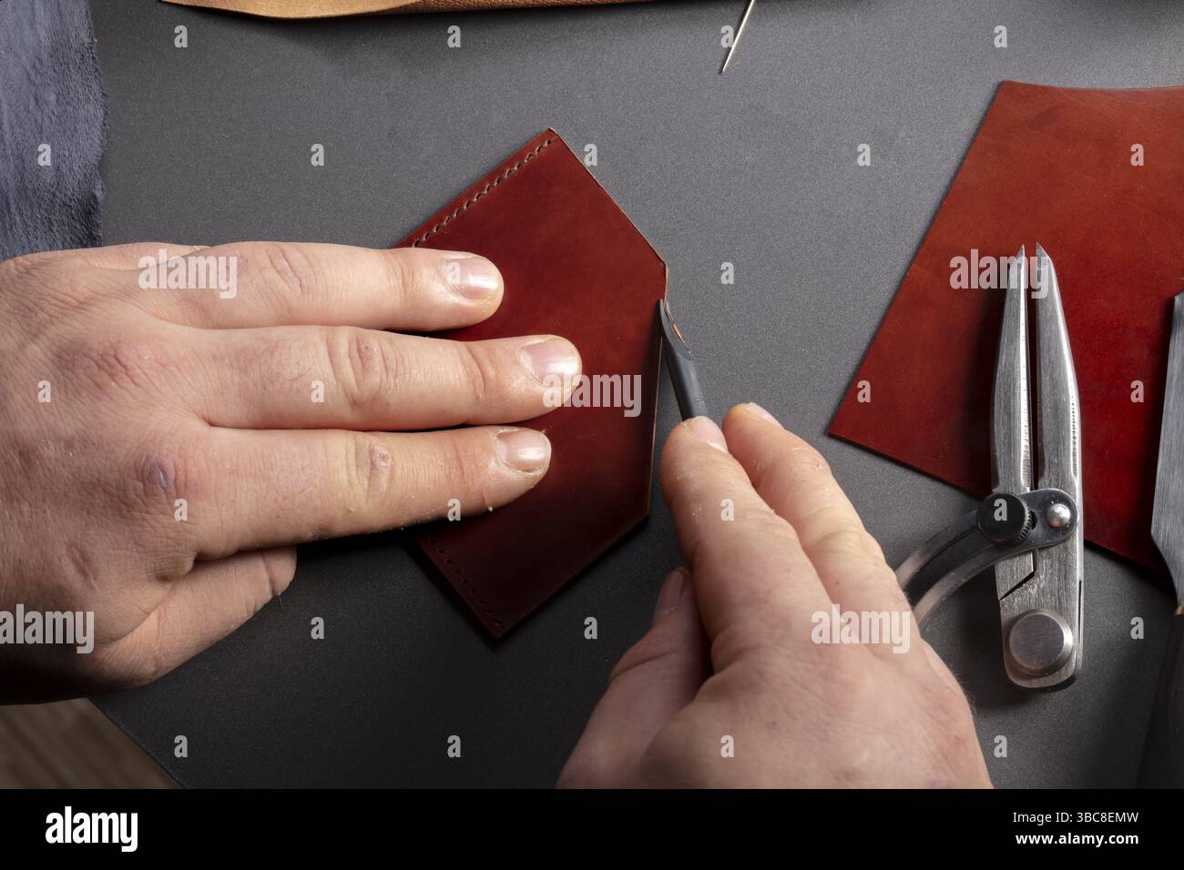 The process of making leather goods. The hands of the master craftsman ...