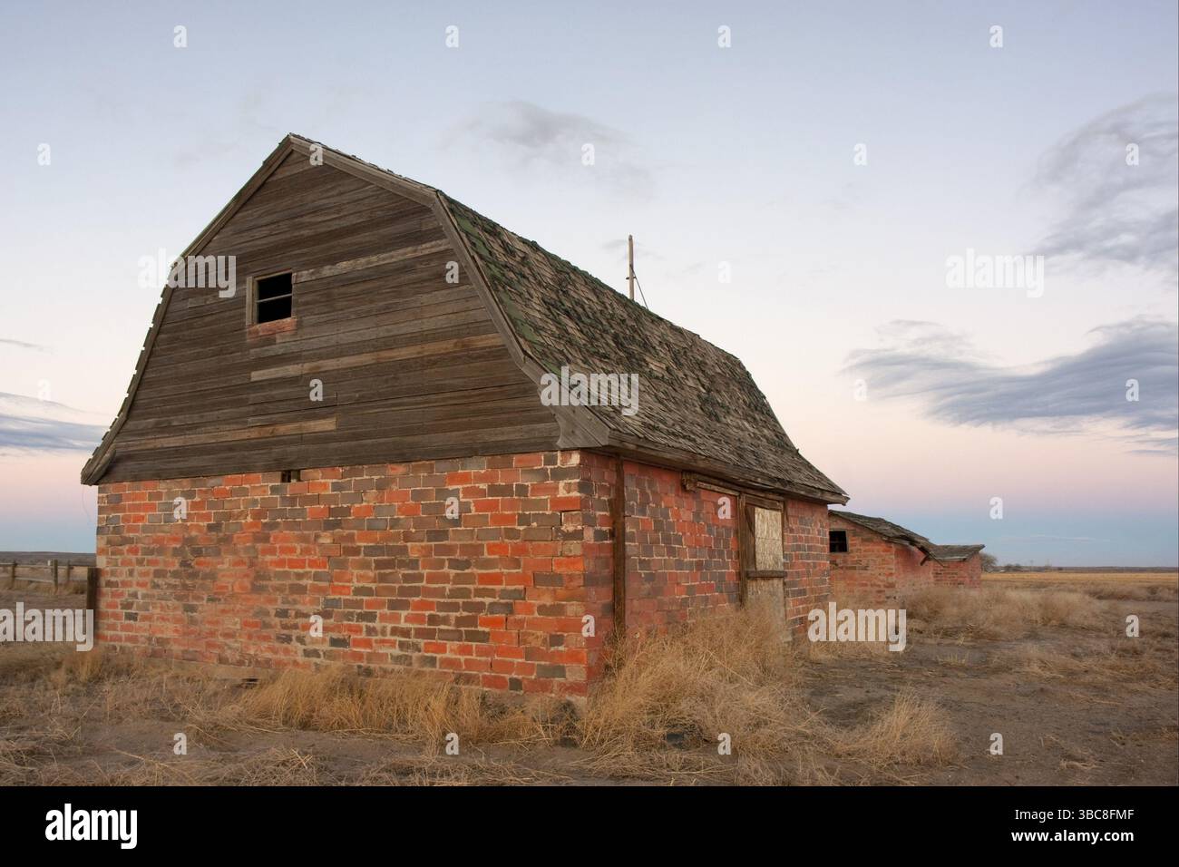 Abandoned brick barn and farm buildings in eastern Colorado prairie at ...