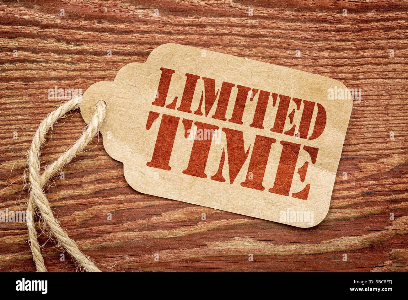 Limited time offer sign - red stencil text on a paper price tag against ...