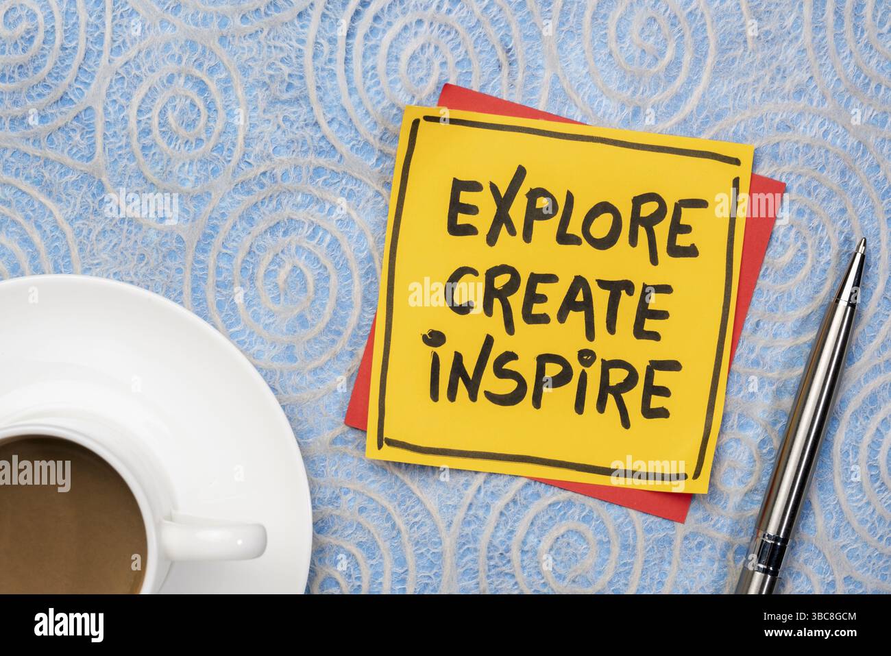 Explore, create, inspire- inspirational reminder on sticky note with a ...