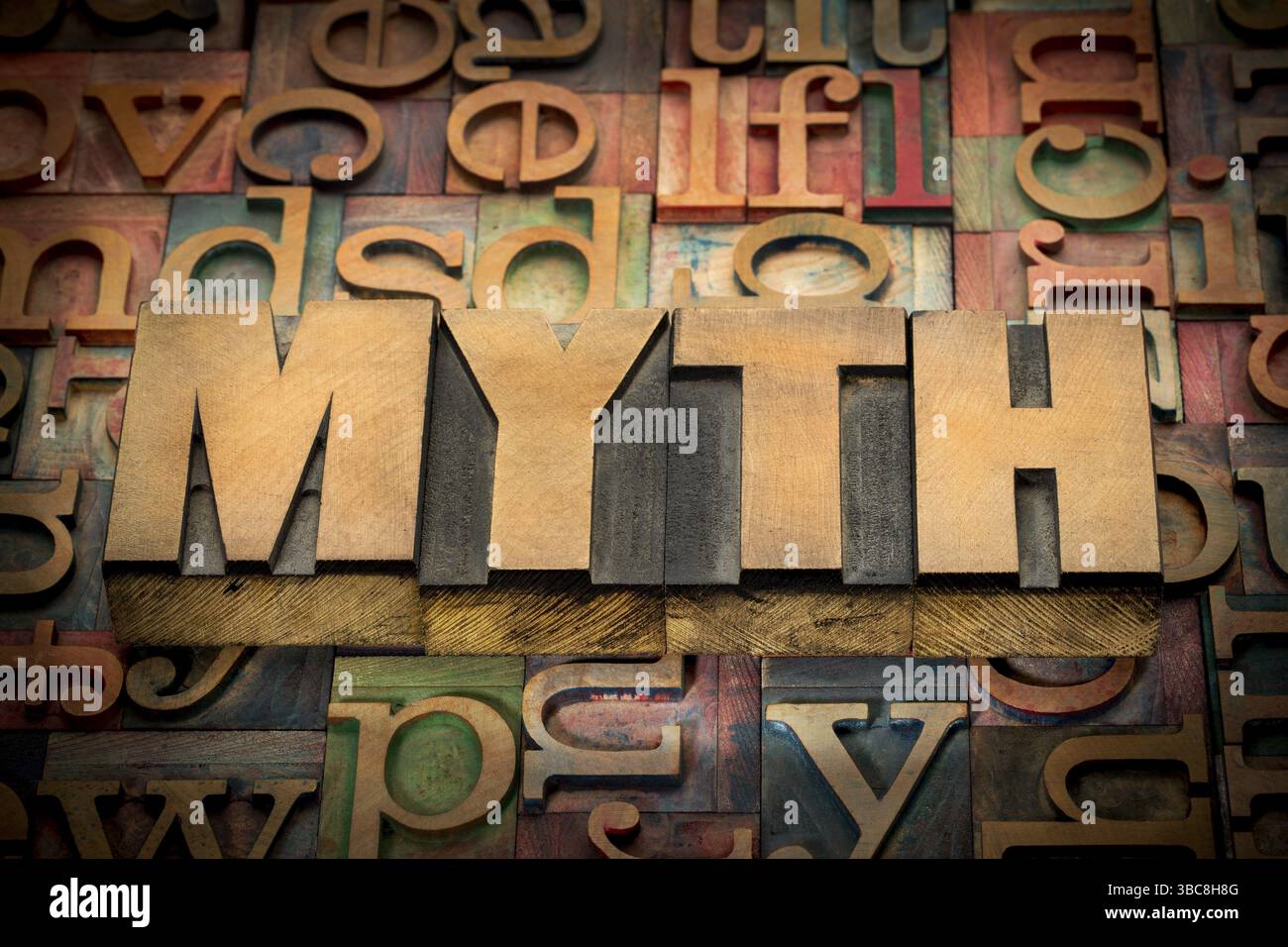 Myth word in wood type against background of letterpress printing ...