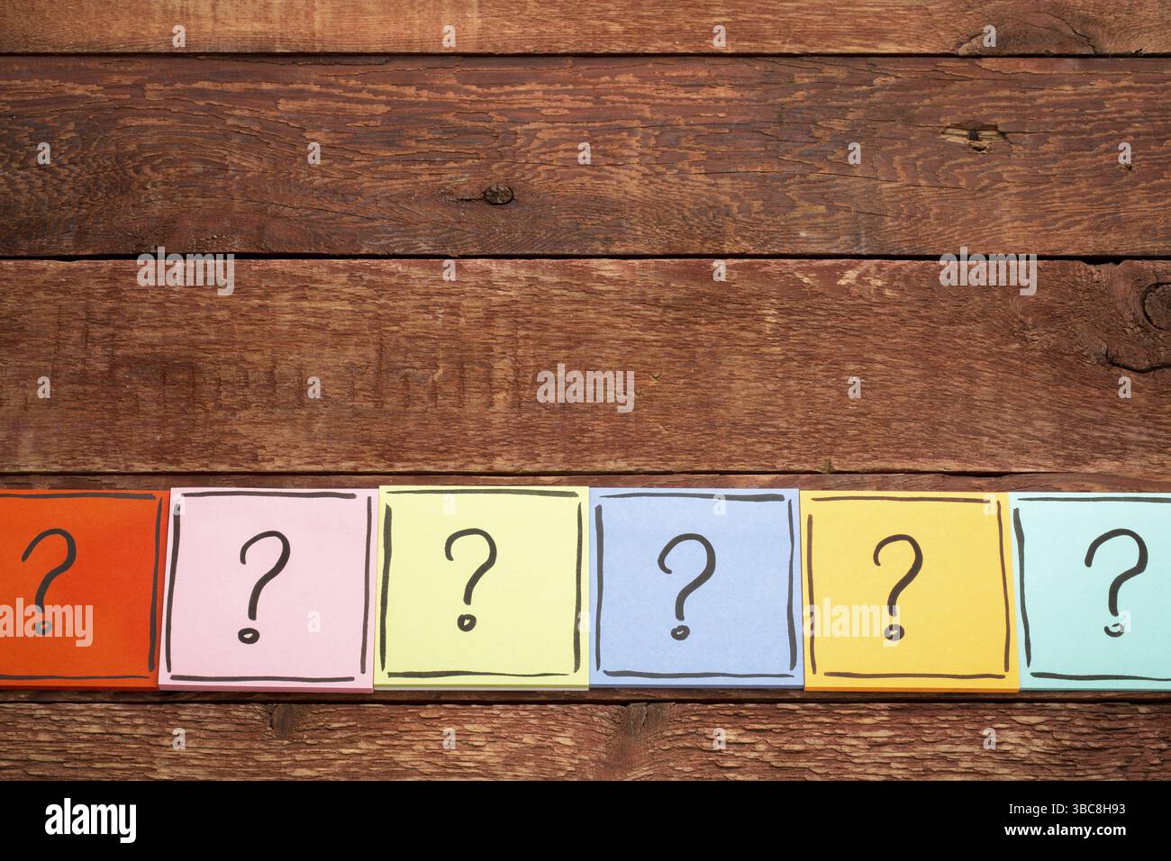 Question mark concept - handwriting in black ink on colorful sticky ...