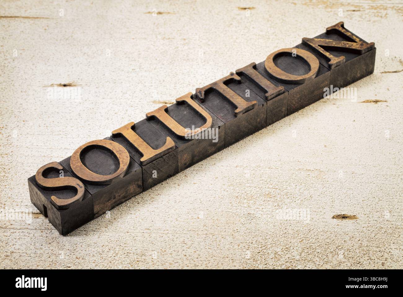 Solution word in vintage letterpress wood type against white painted ...