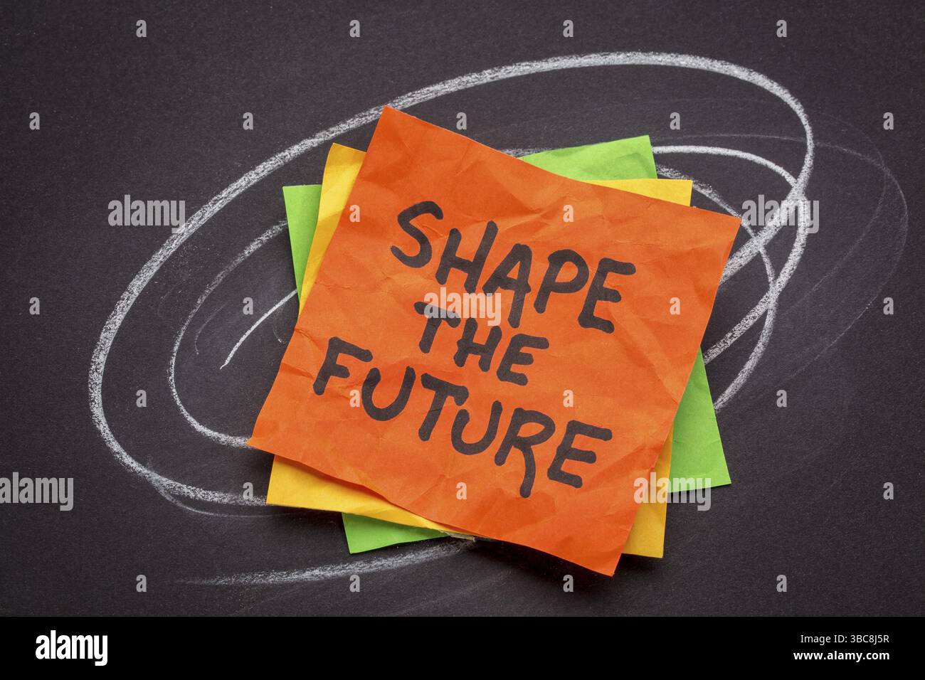 Shape the future - motivational slogan on sticky notes against black ...