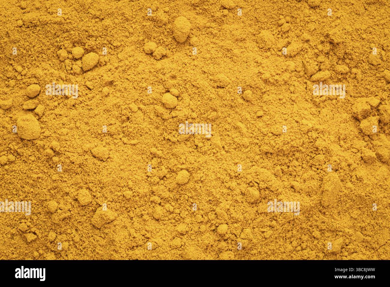 Turmeric root powder background and texture Stock Photo - Alamy
