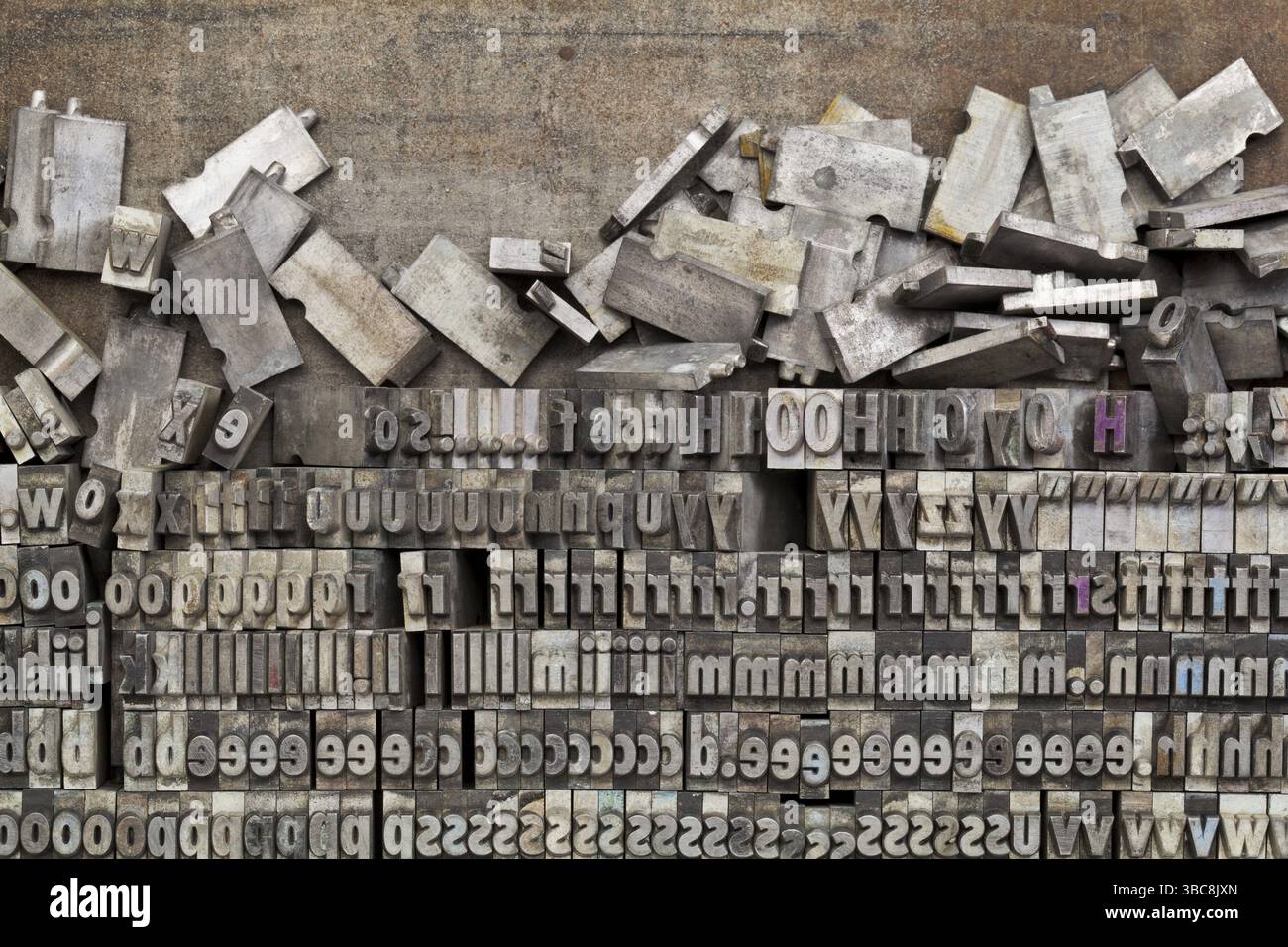 Disorganized vintage grunge metal letterpress printing blocks on a tray ...