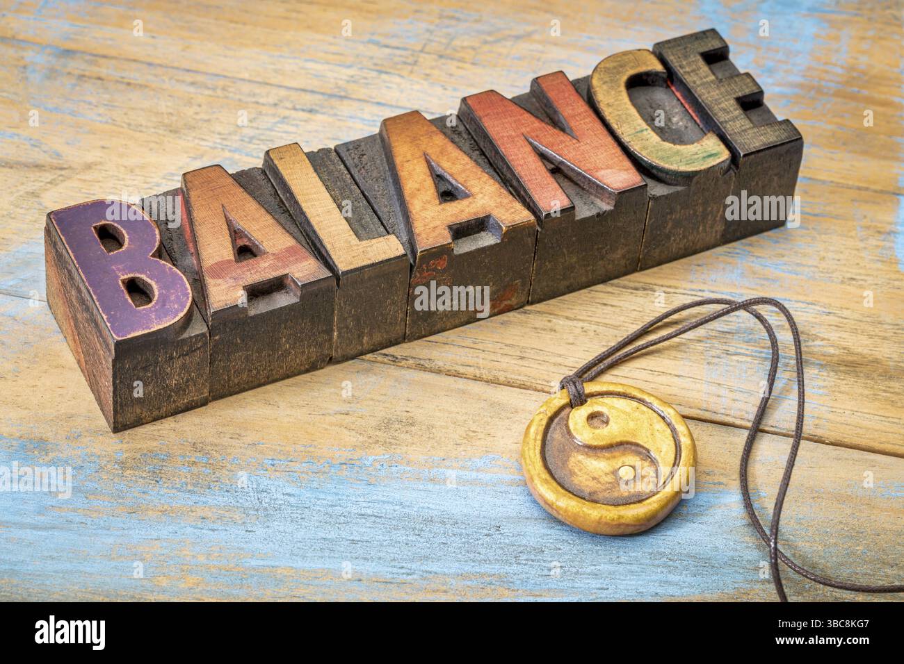 Balance word in vintage letterpress wood type with ying and yang symbol ...