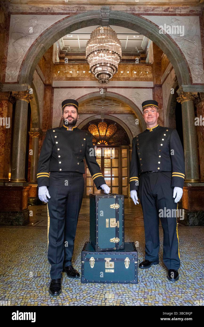 EDITORIAL USE ONLY Porters dressed in uniforms from the 1900s at the ...