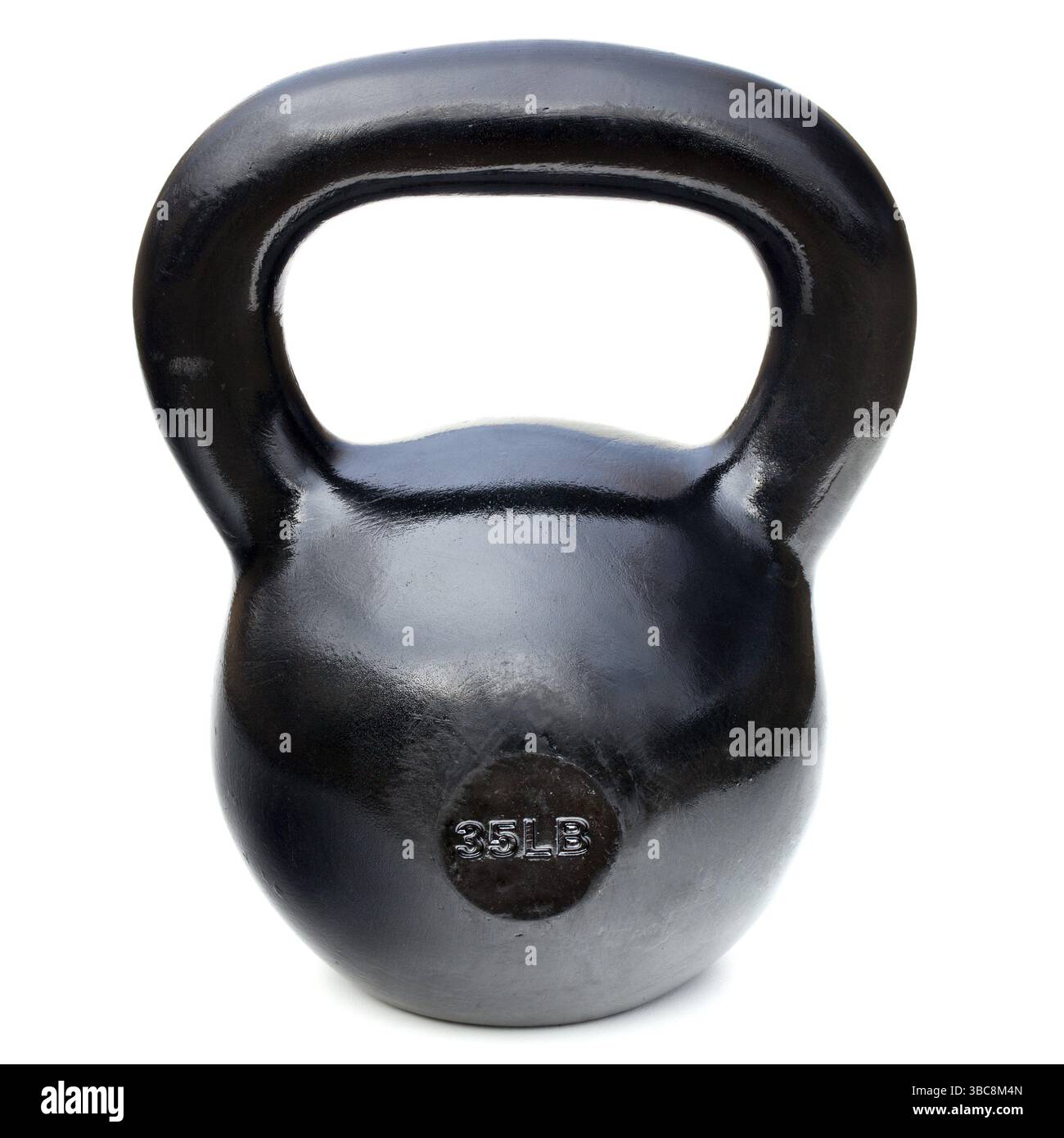 Black shiny 35 lb iron kettlebell for weightlifting and fitness ...