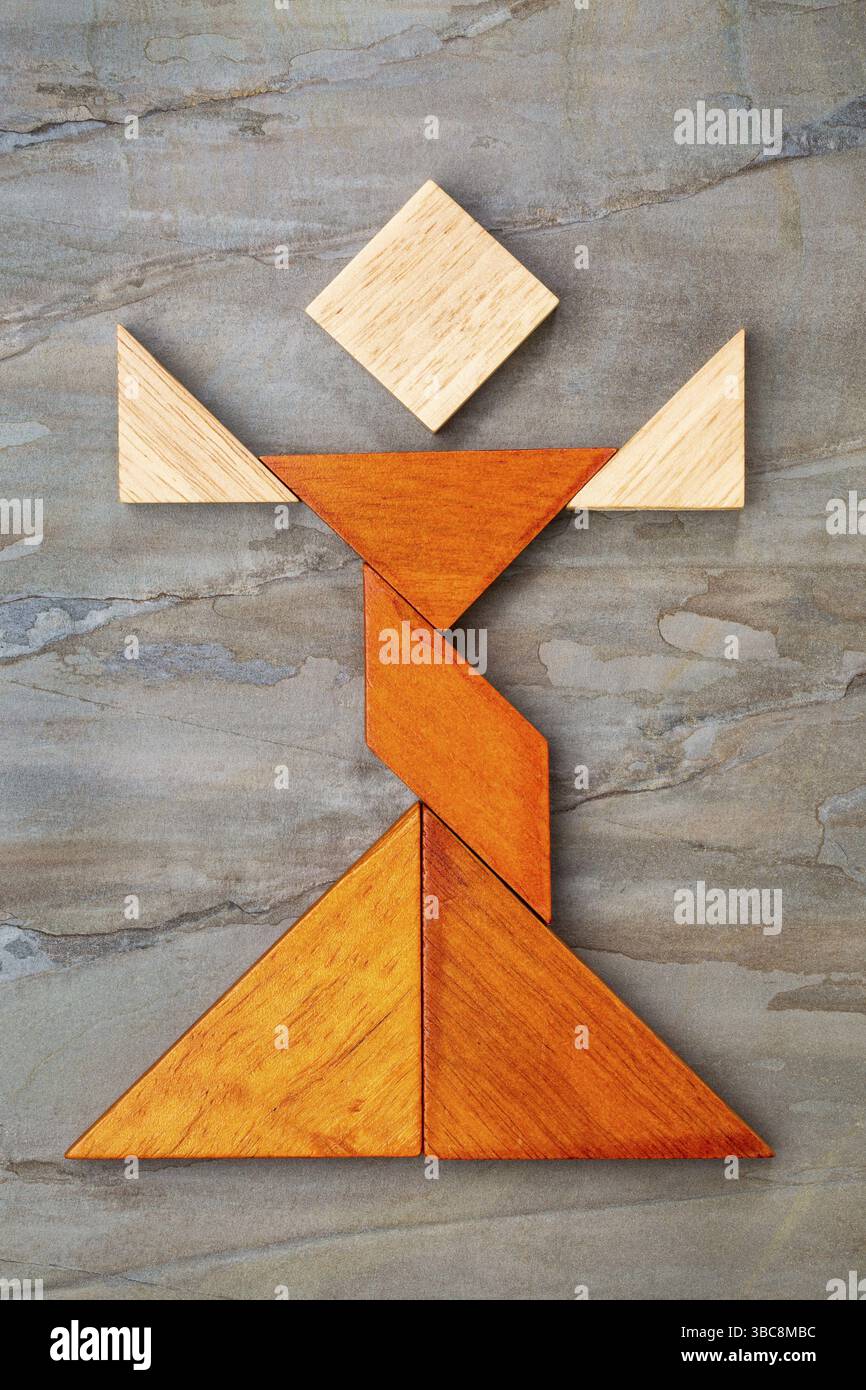 Abstract figure of a female dancer built from seven tangram wooden ...