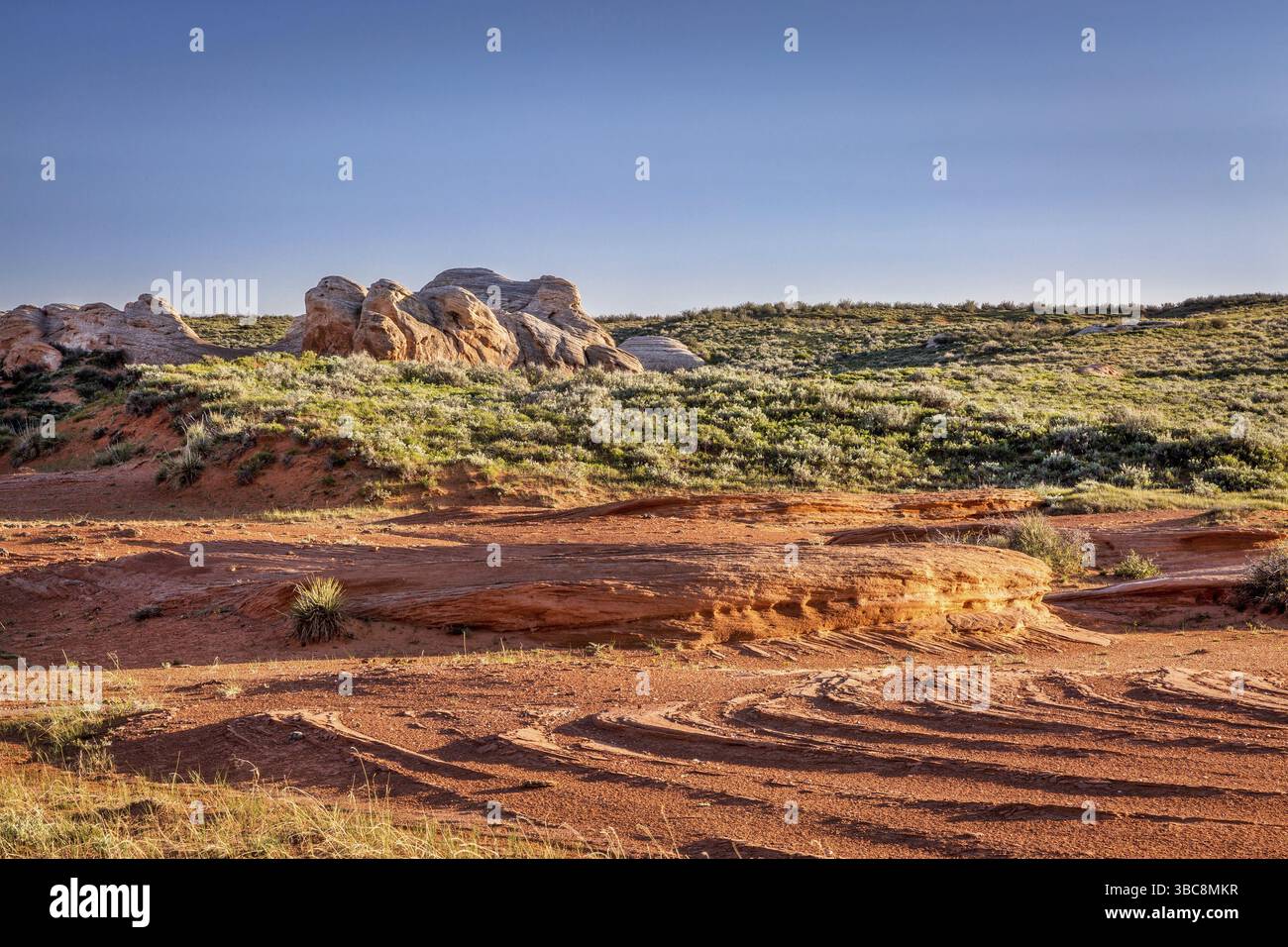 Red sandstone formation and prairie in Sand Creek National Monument at ...