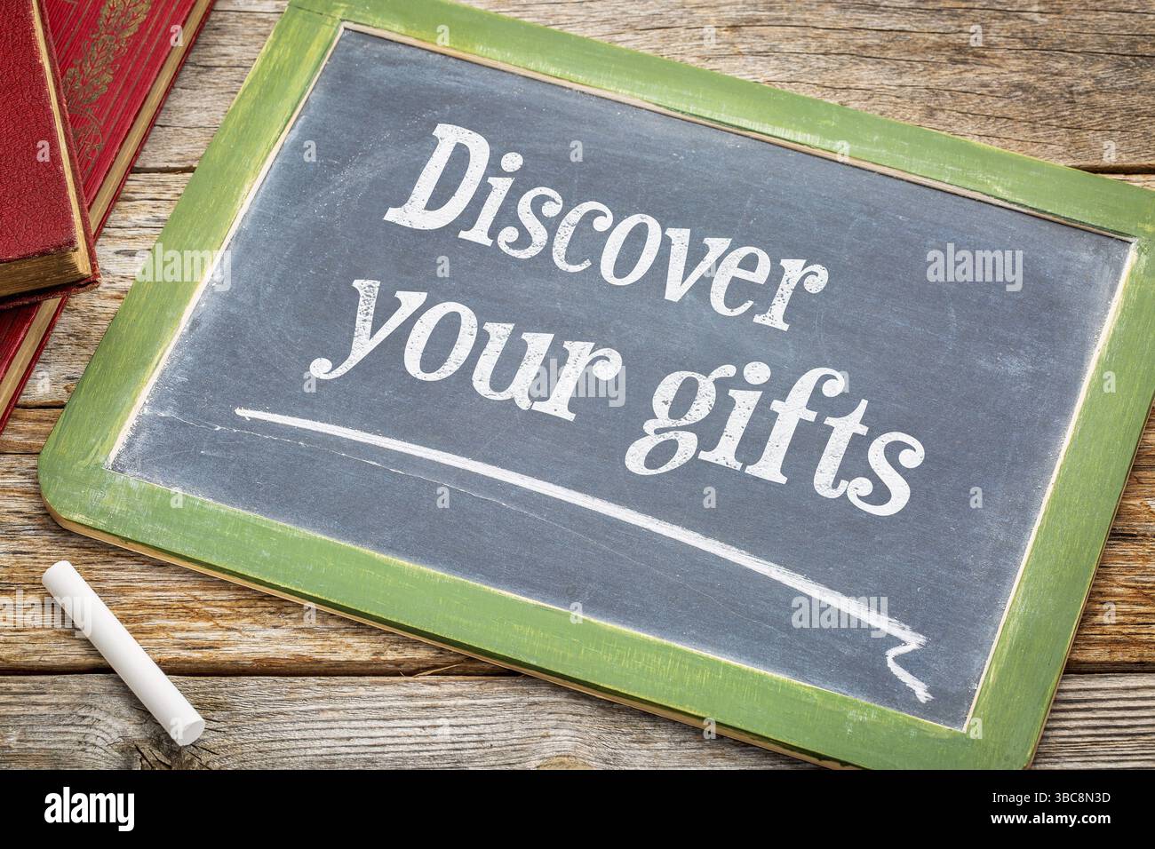 Discover your gifts - white chalk text on a slate blackboard with a ...