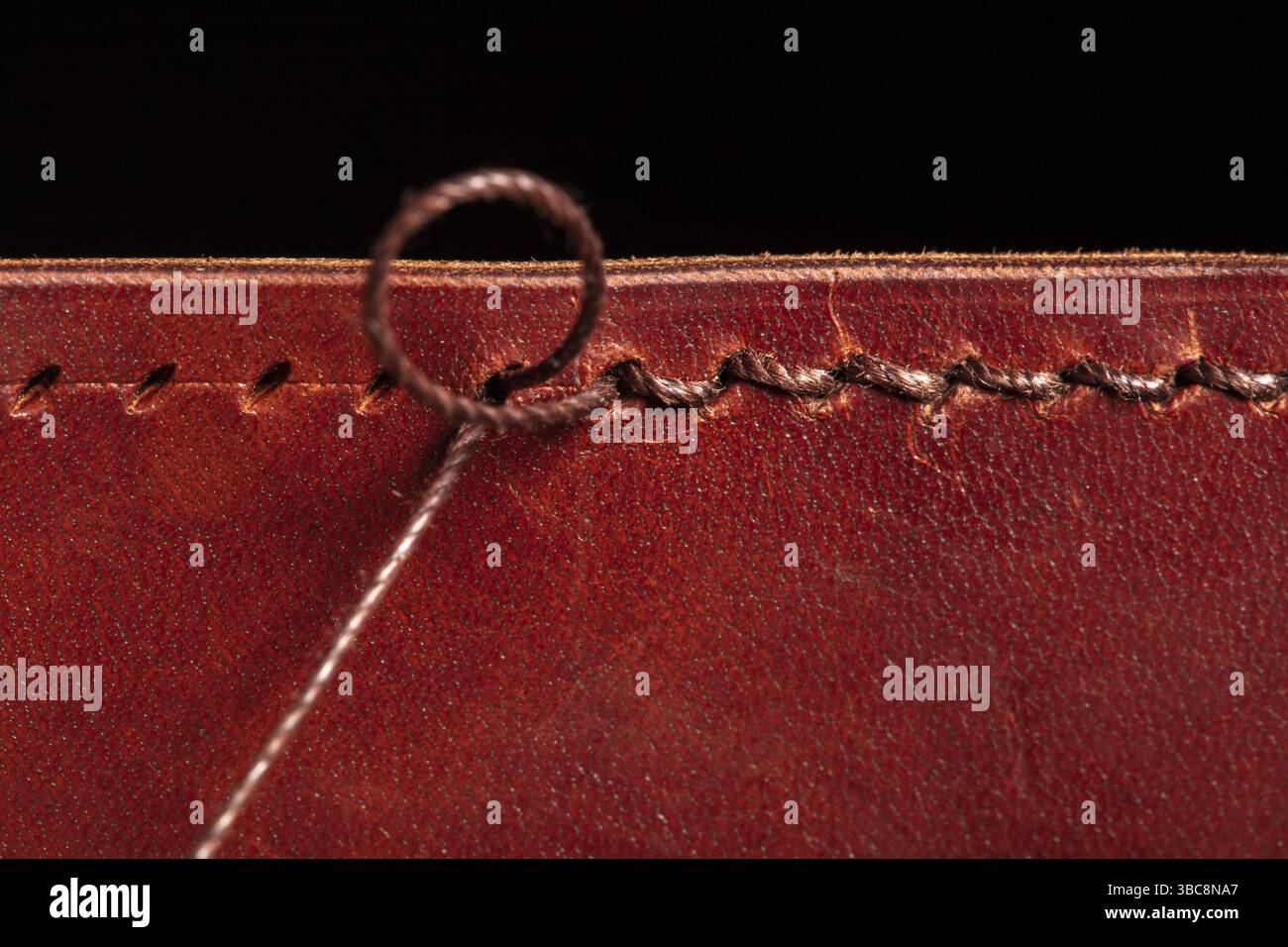 A seam with threads on a leather product Stock Photo - Alamy