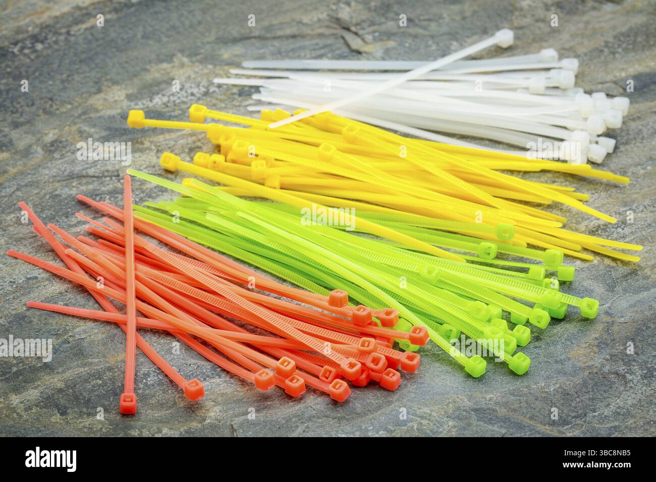 Self-locked plastic zip cable ties in different colors over slate rock ...