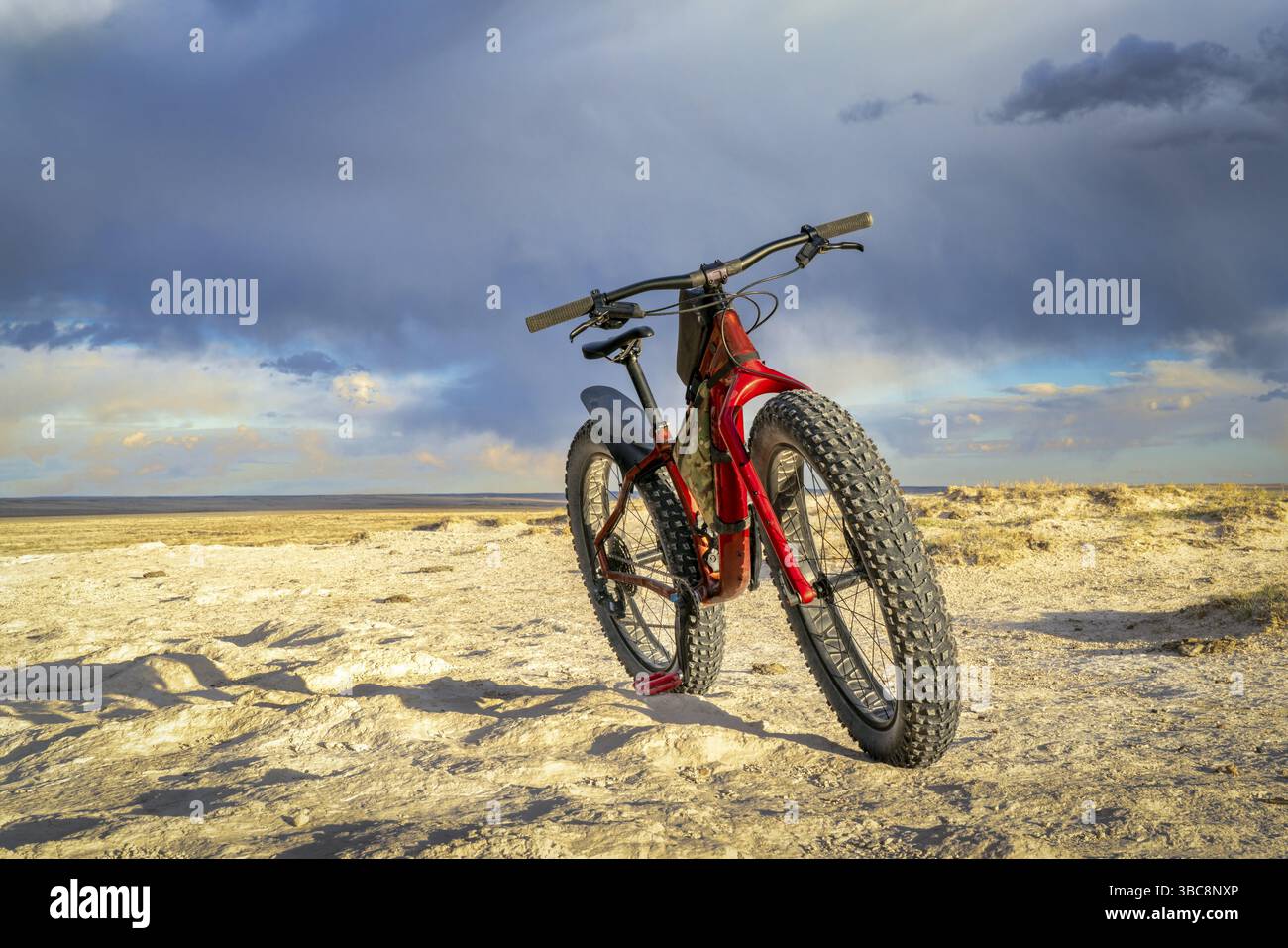 Mountain fat bike in badlands with storm clouds in background - Main ...