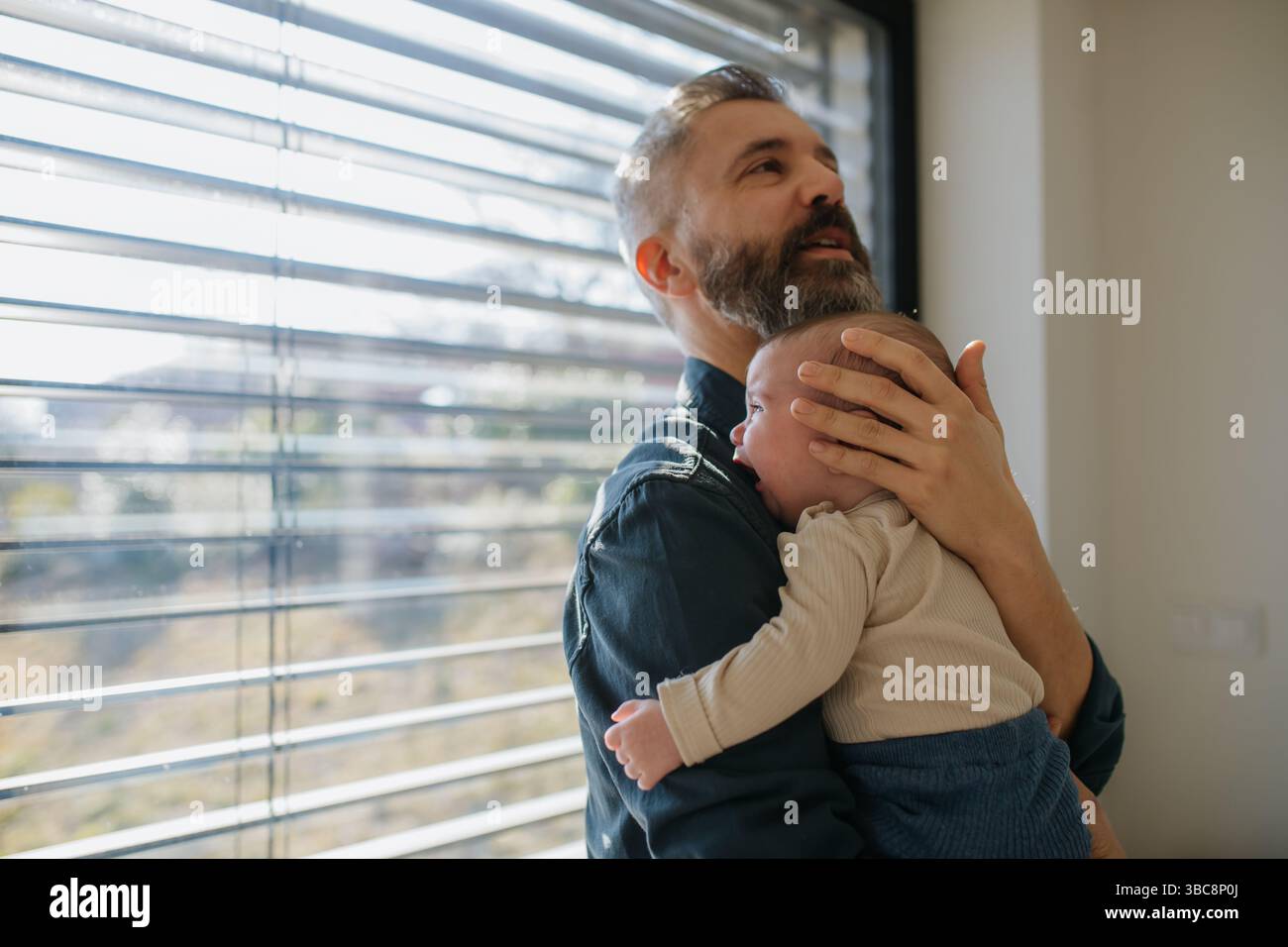 Father comforting his crying baby son Stock Photo - Alamy