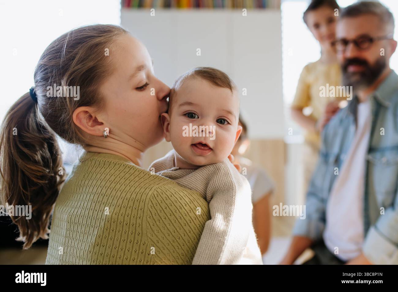 Big sister holding small little brother in her arms, taking care Stock ...