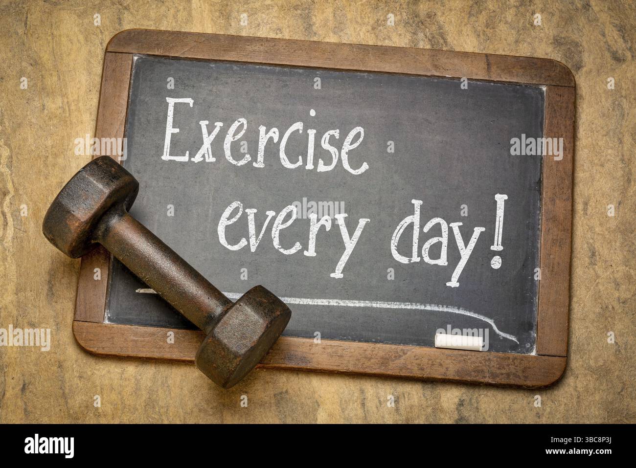 Exercise every day - white chalk text on a slate blackboard with a ...