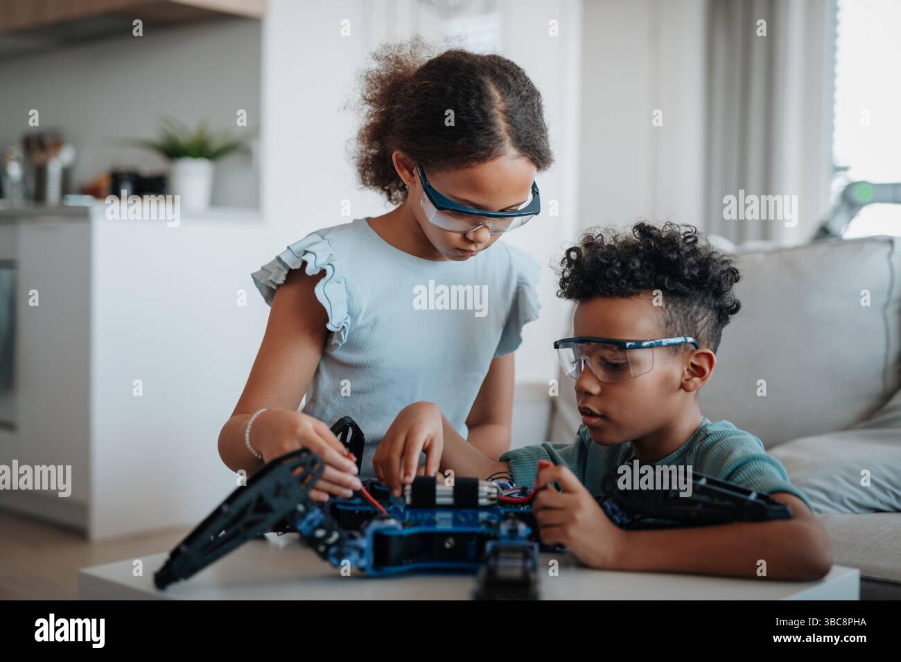 Kids building their first homemade robot at home Stock Photo - Alamy
